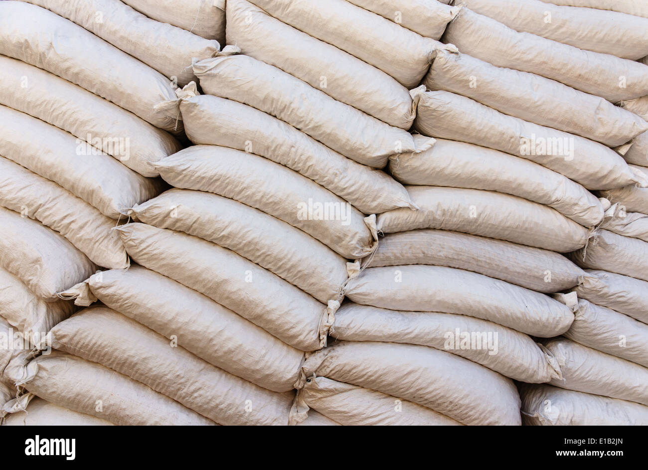 Pile sacks in warehouse Stock Photo - Alamy