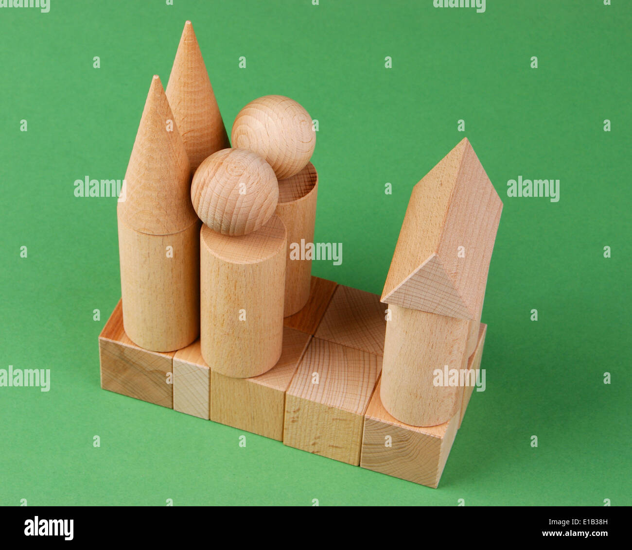 wooden geometric shapes on a green background Stock Photo - Alamy