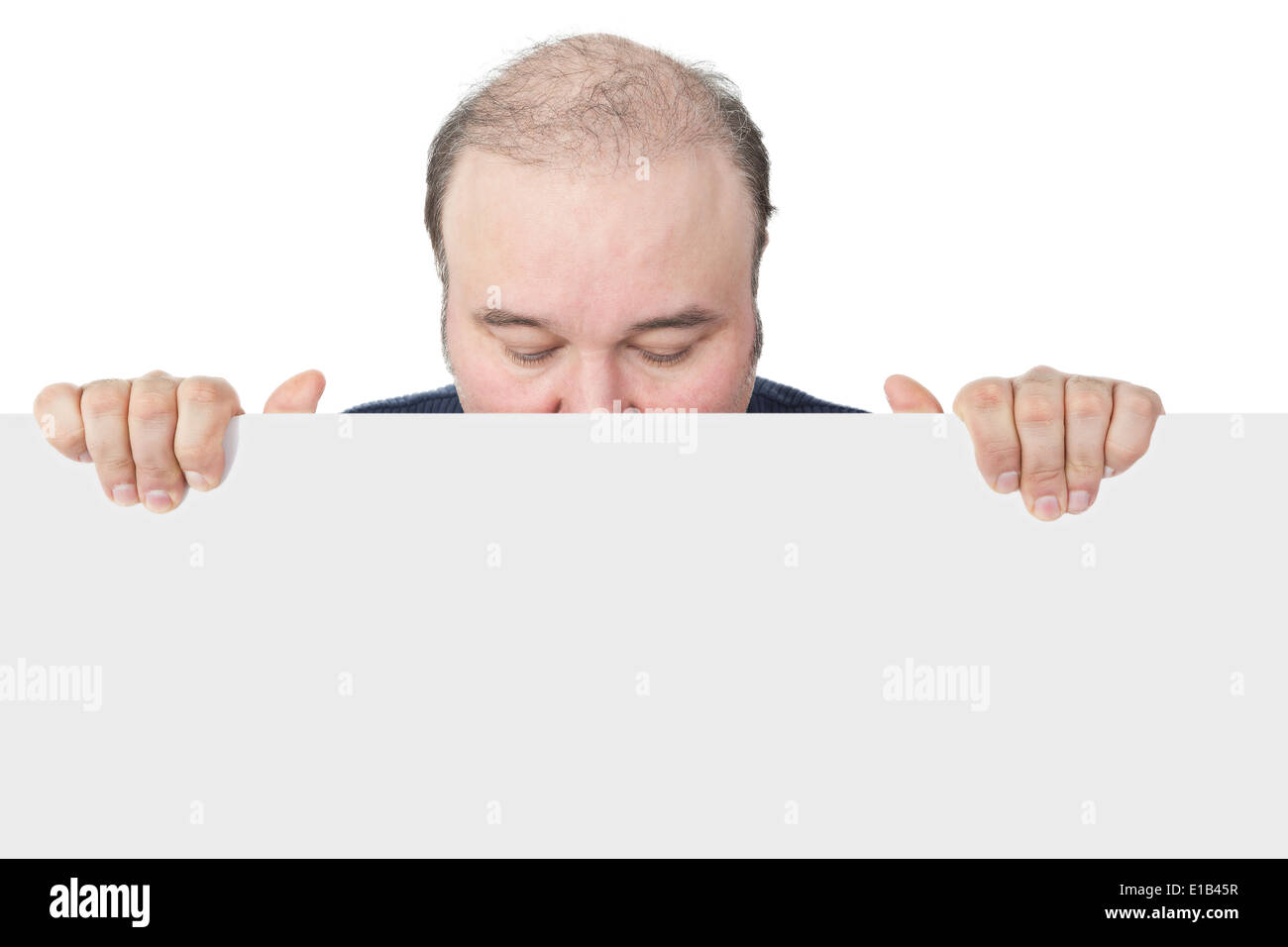 Businessman holding a blank white sign suitable for advertising looking ...