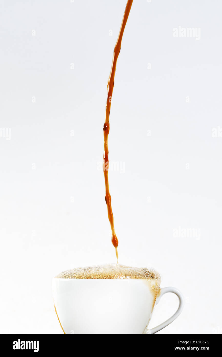 Pouring coffee in a cup on white background. Coffee break, breakfast ...