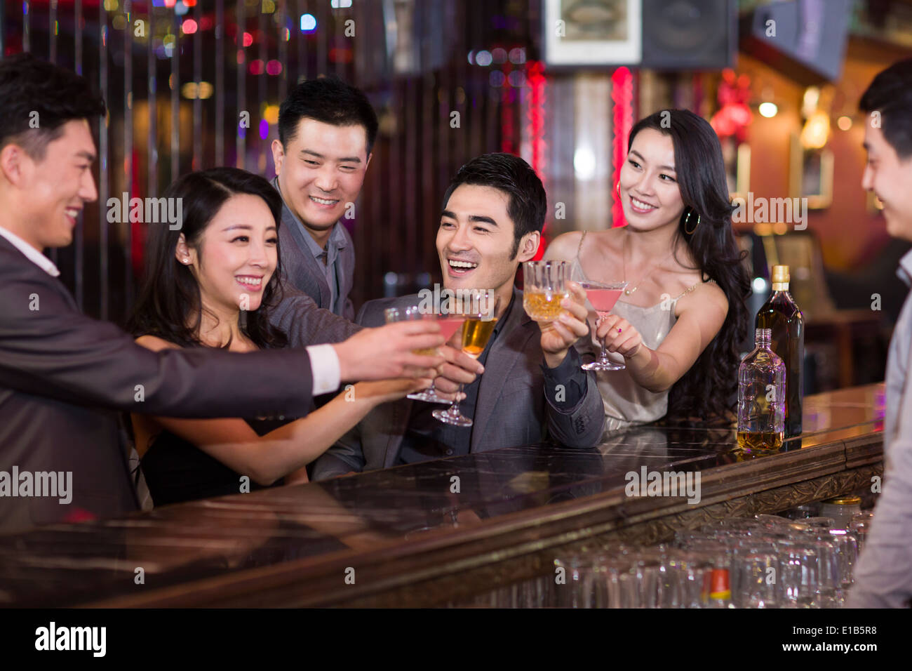 Five friends sitting bar counter hi-res stock photography and images ...