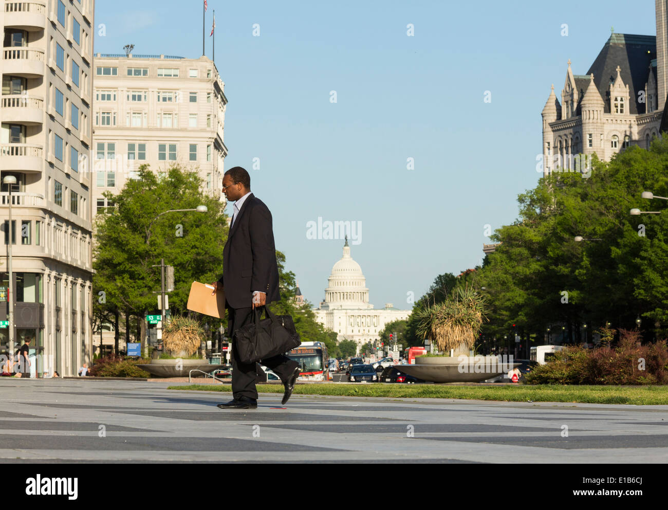 African American man in business suit walks across Freedom Plaza in ...