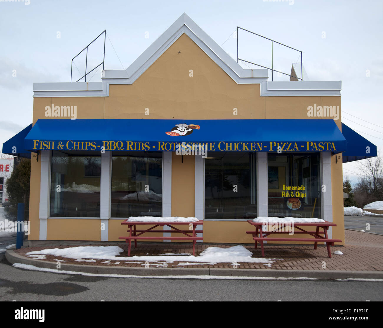 Fast food restaurant advertising fish and chips, chicken, pizza Stock ...