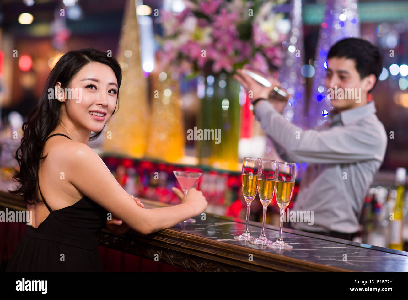 Woman holding two drinks bar hi-res stock photography and images - Alamy