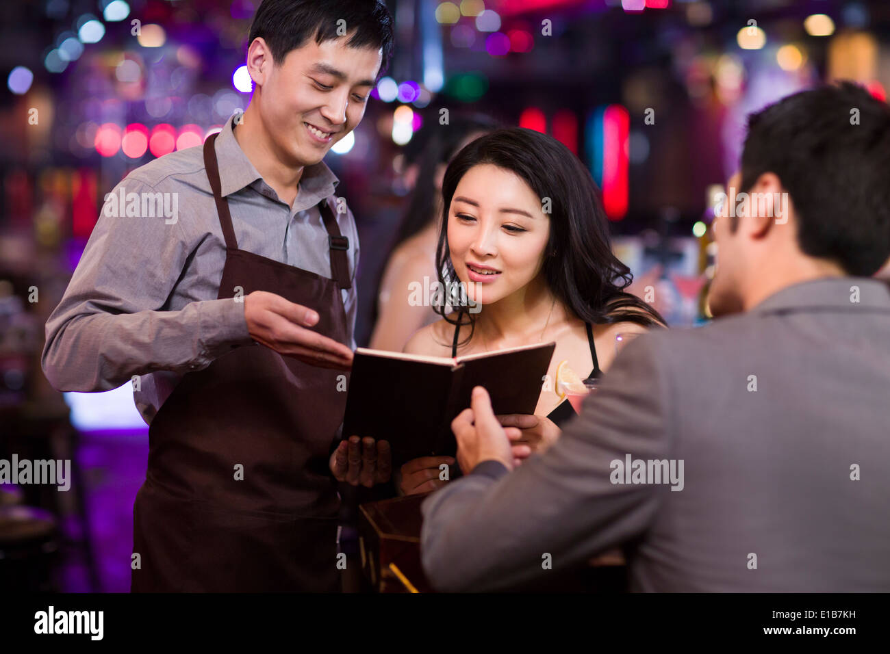 Young couple ordering food in restaurant Stock Photo - Alamy