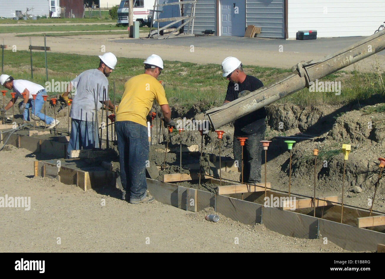 Concrete is being poured for the foundation of a new office building at ...