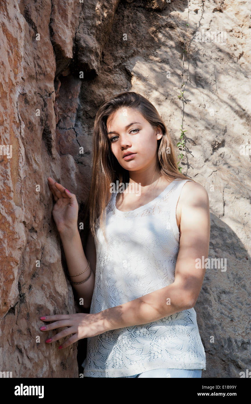 Portrait of a girl at the rock girl posing for a photographer standing ...