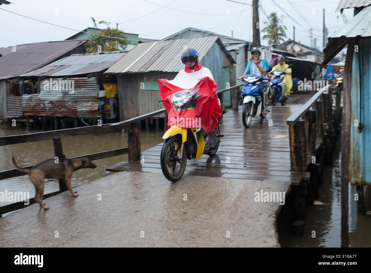 Motorcyclists in the rain at Duong Dong on Phu Quoc Island in Vietnam ...