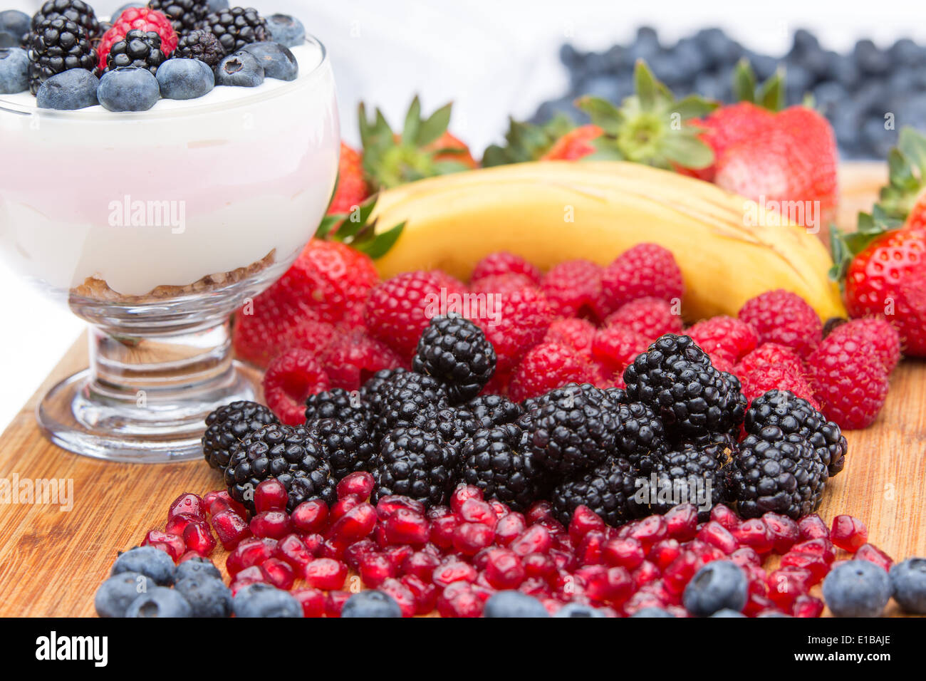 Preparing a delicious creamy fruit dessert with rows of colourful clean ...