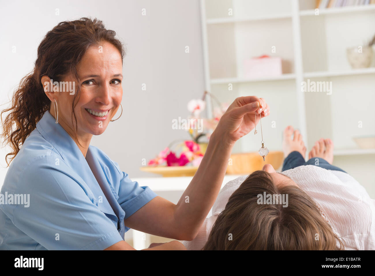 Alternative medicine therapist using pendulum to make a diagnosis Stock ...