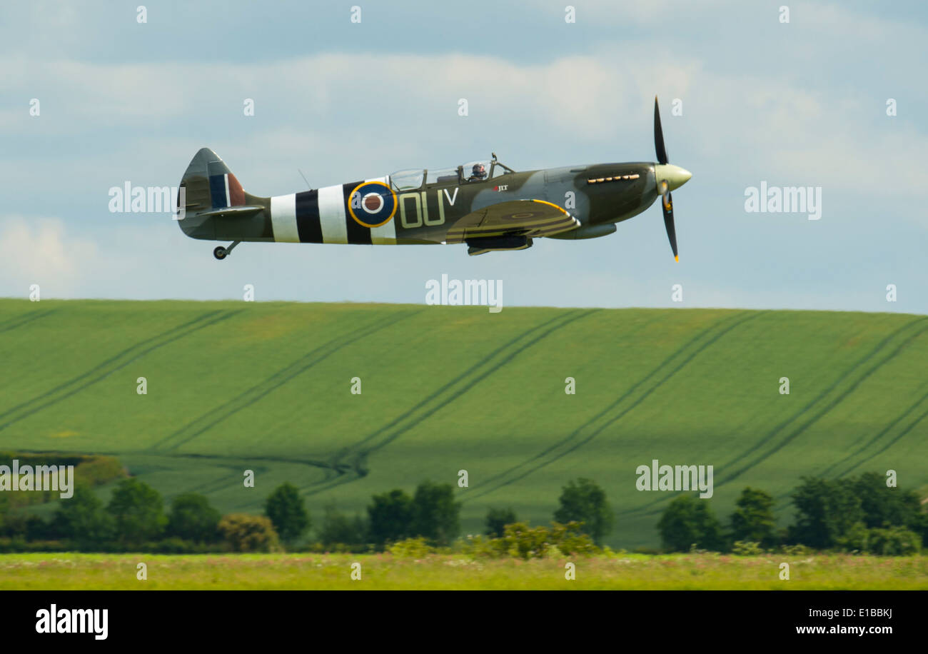 DUXFORD, ENGLAND. A Supermarine Spitfire with the D-Day livery takes to ...