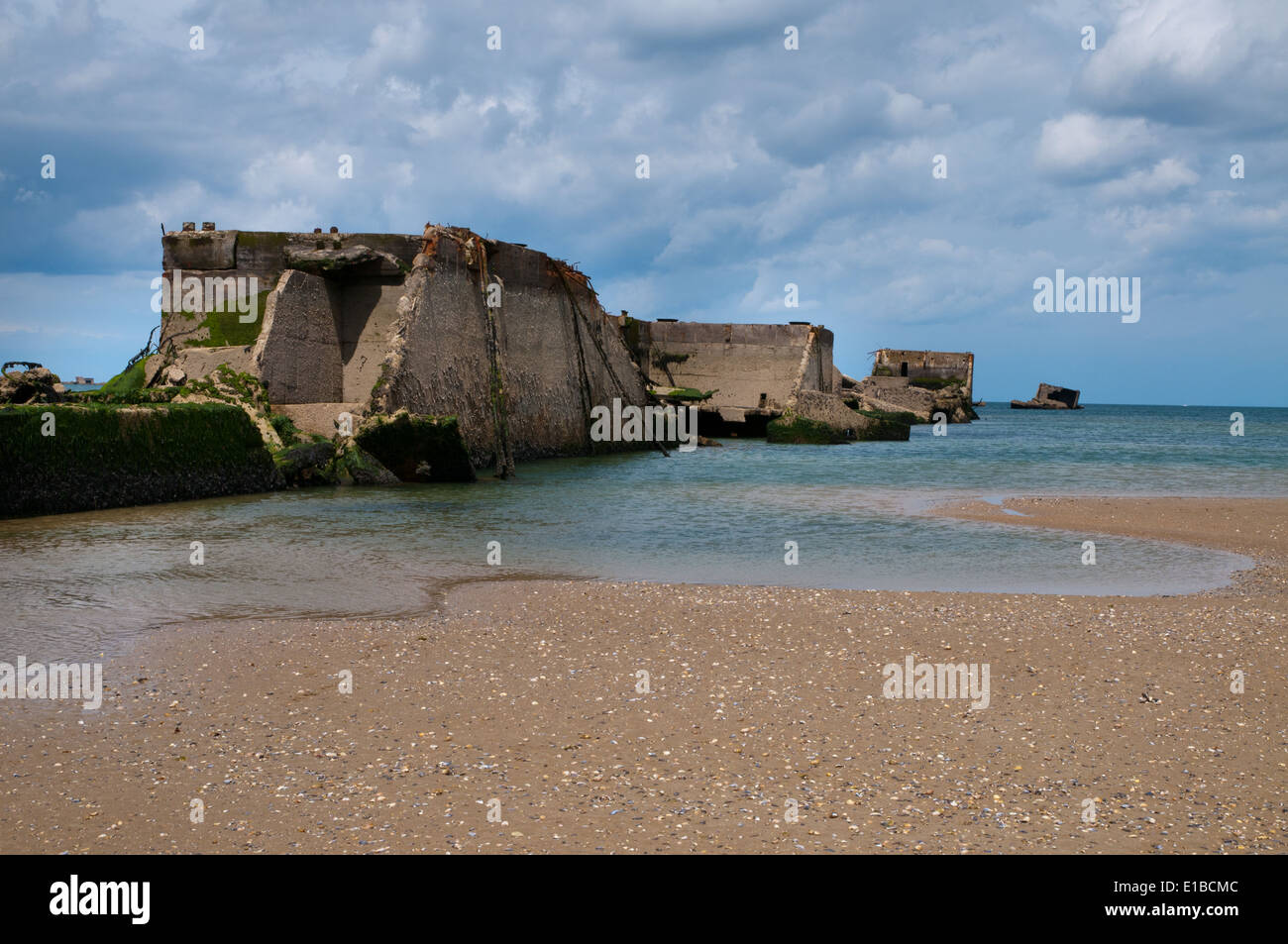 Sections of Mulberry Harbour at low tide at Asnelles, Gold Beach during ...