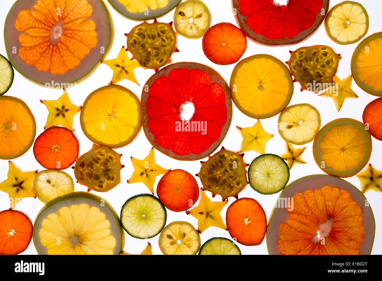 Vibrant background of translucent sliced fresh fruit neatly arranged on ...