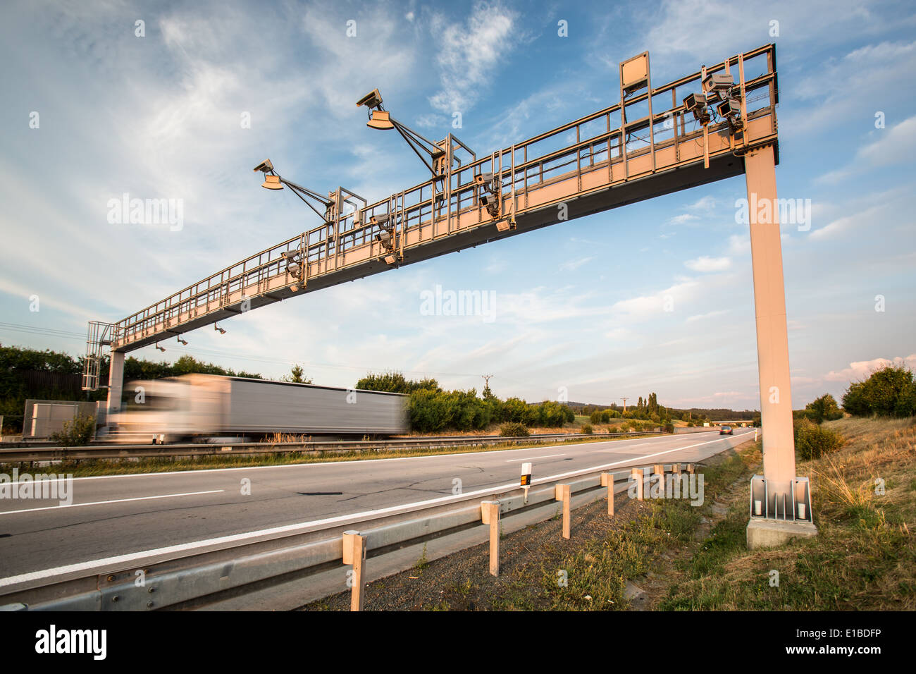 Truck passing through a toll gate on a highway (motion blurred image ...
