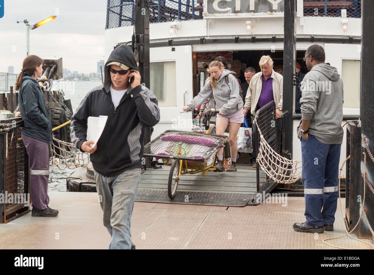 Passengers getting off of a Toronto ferry upon arrival at Ward's Island ...