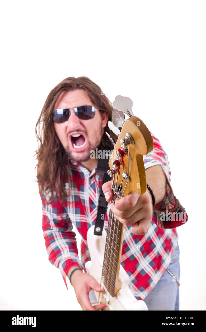 man with face expression pointed his electric bass guitar at the camera ...
