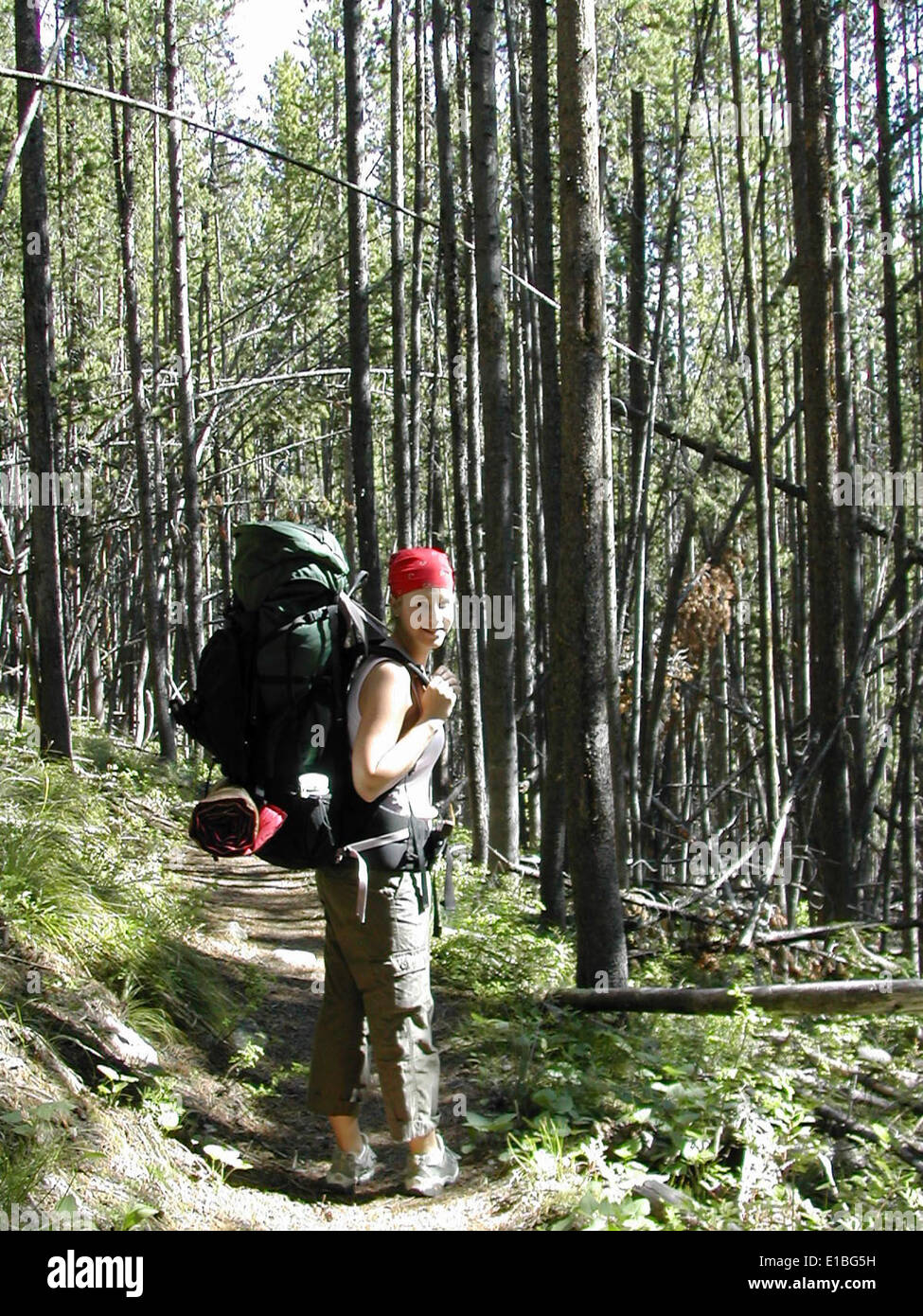 A person walking on a trail in a natural setting, showcasing outdoor ...