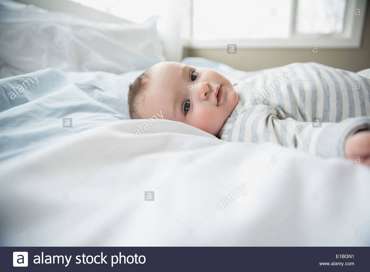 Baby laying on bed hi-res stock photography and images - Alamy