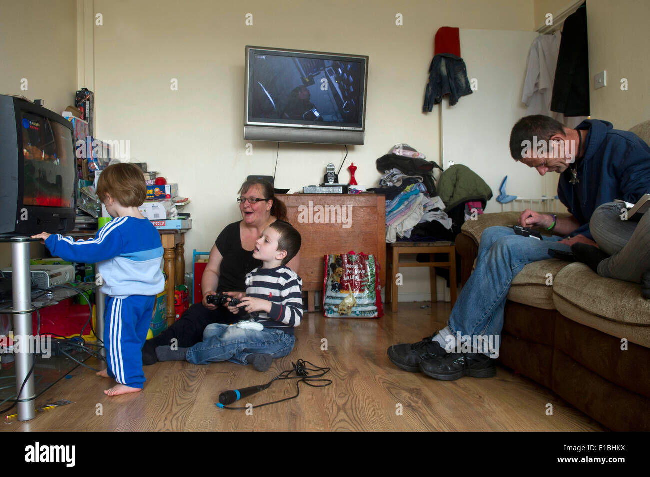 Poor Family Living Room With Tv Naughty Children Parenting. Annoyed