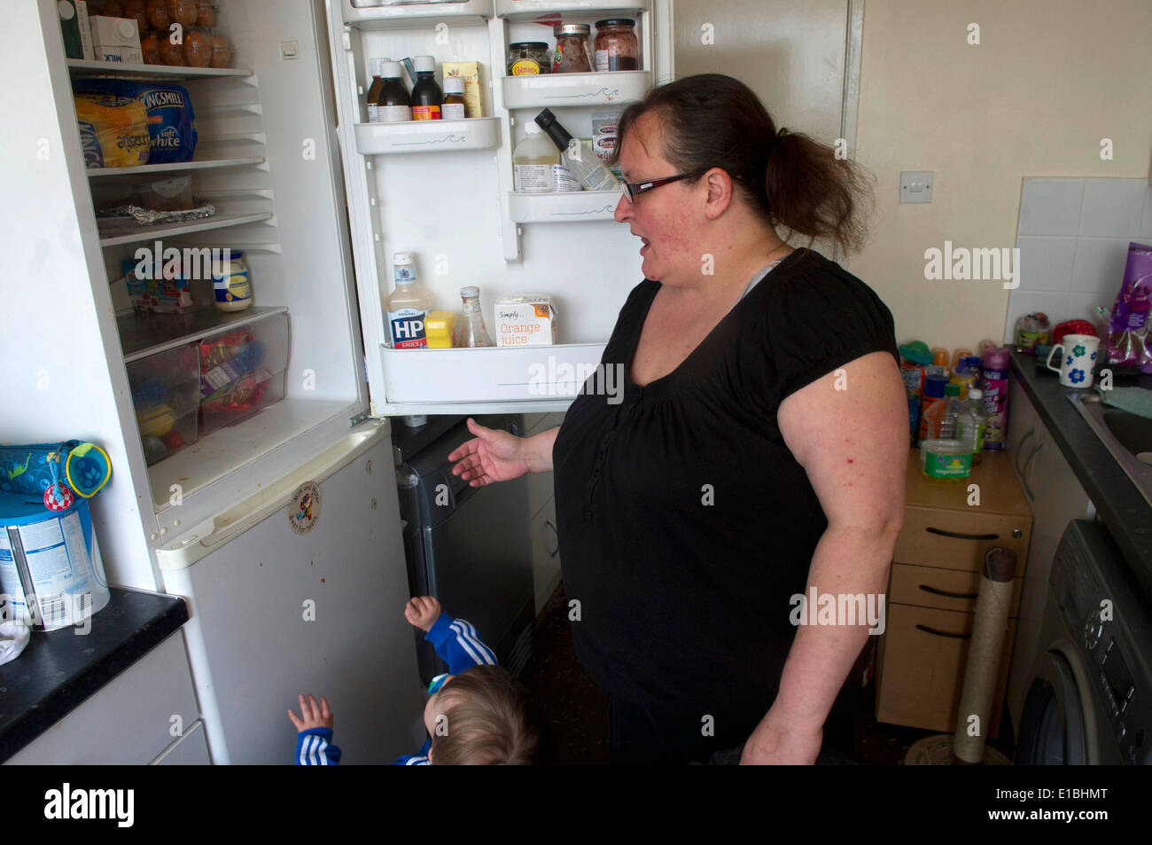 Breadline Britain looking for food in fridge Stock Photo - Alamy