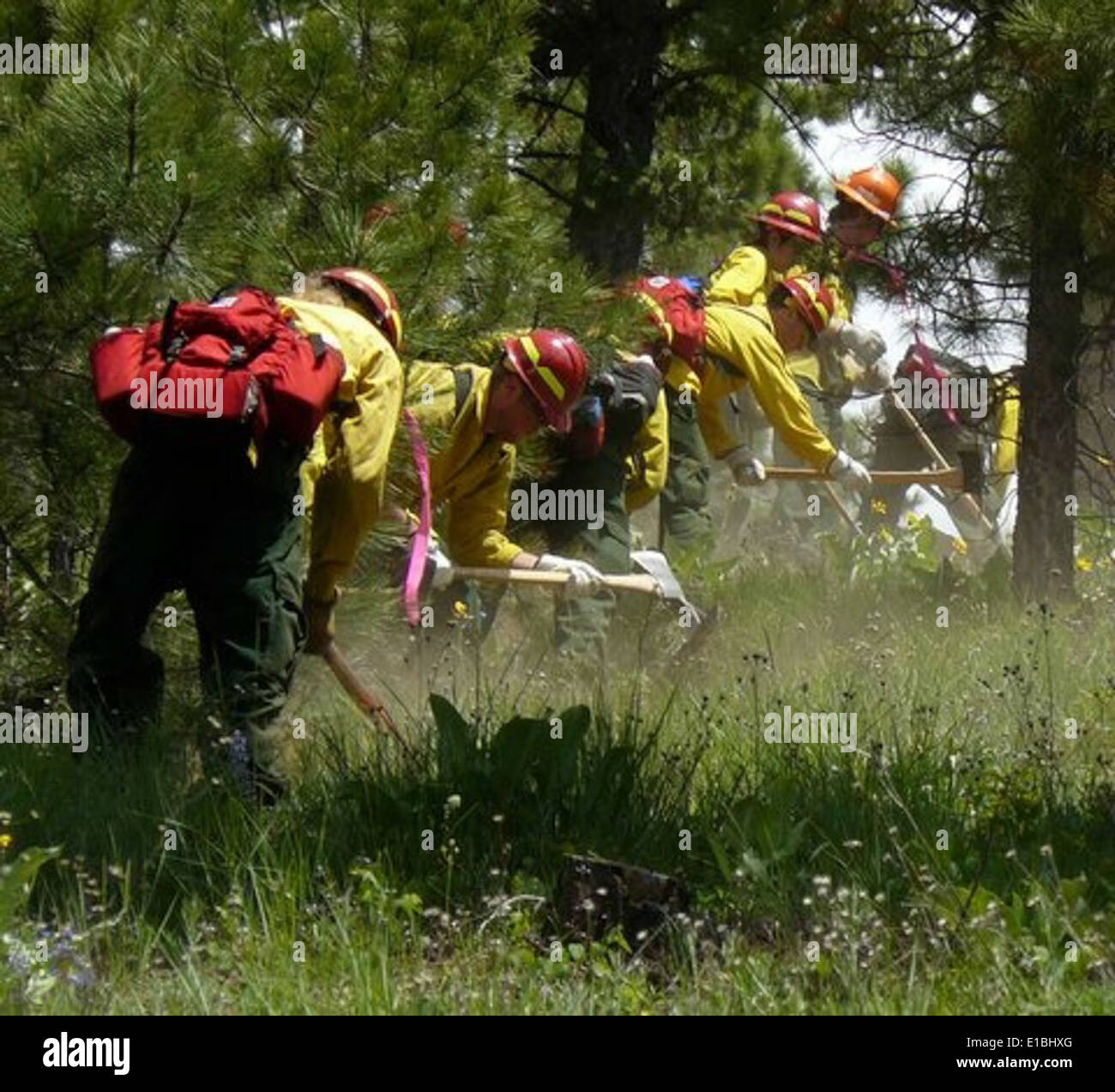 A fire crew is seen digging a firebreak line during wildfire ...