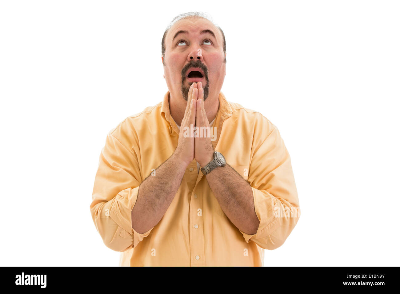 Middle-aged man praying to heaven for help clasping his hands in ...