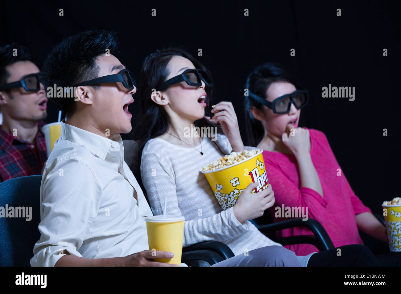 Young couple watching 3D movie in cinema Stock Photo - Alamy