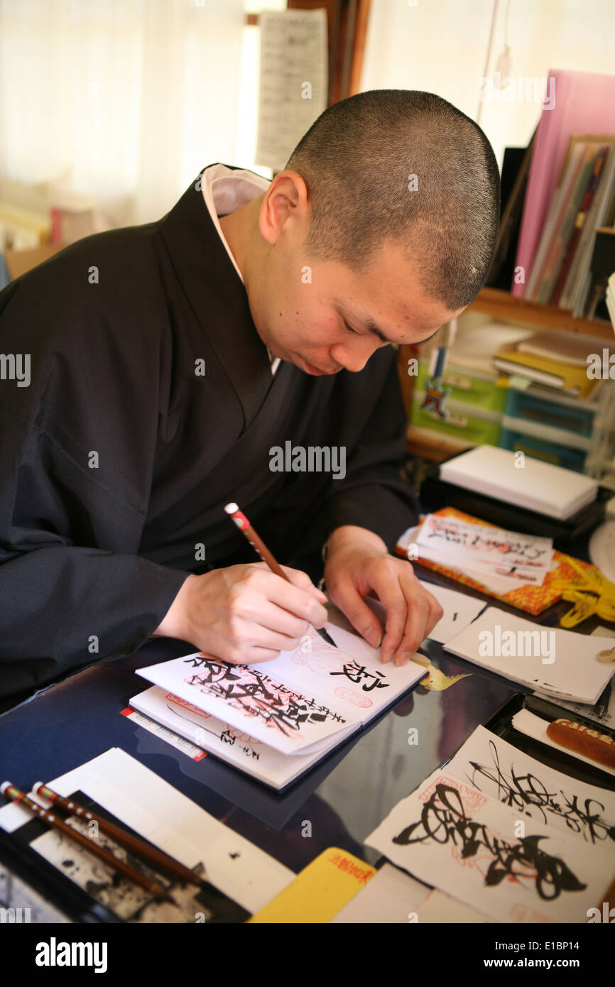 Monk writing temple details into visitors book in Amida-do Hieizan Hiei ...