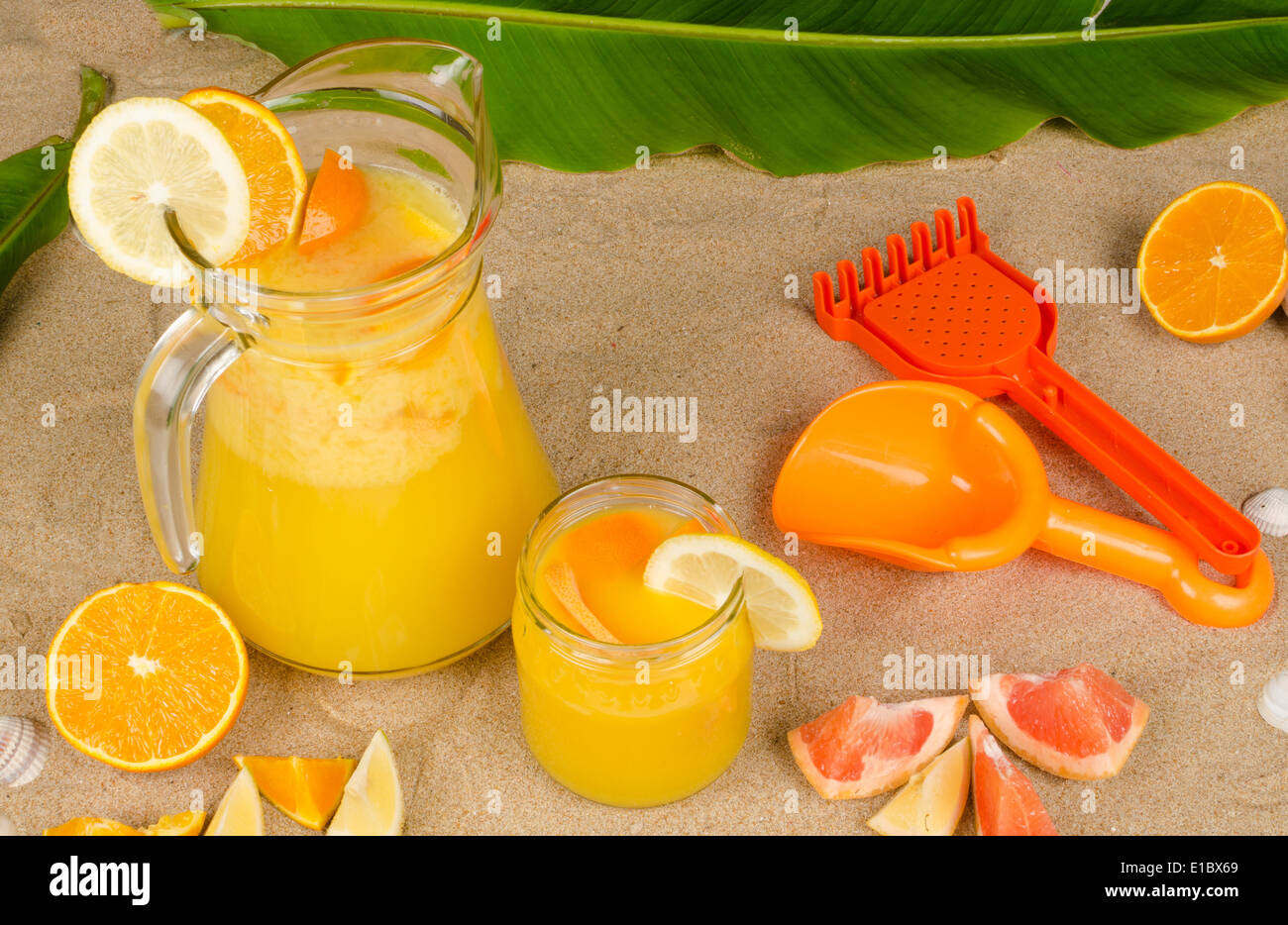 Freshly squeezed fruit juice on beach sand Stock Photo - Alamy