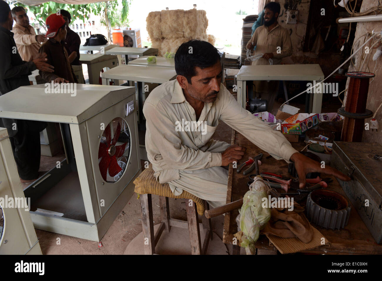 Peshawar, Pakistan. 30th May, 2014. A Pakistani technician repairs a ...