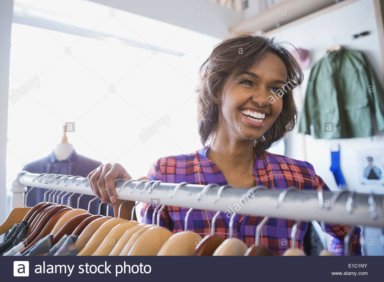 Business owner laughing in clothing shop Stock Photo - Alamy
