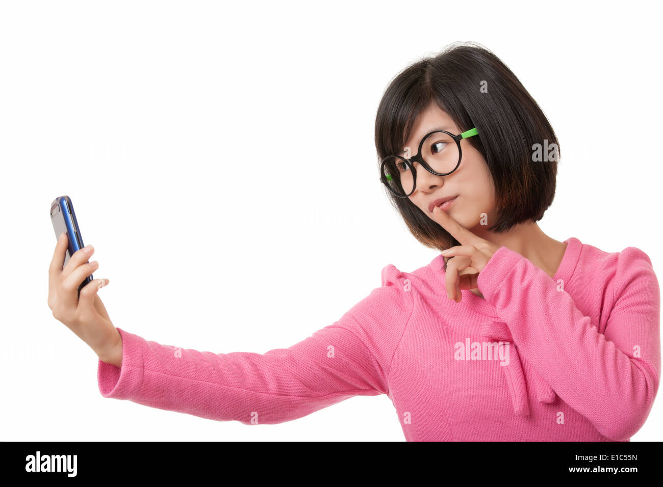 A beautiful Chinese woman using a cell phone to take a selfie on a ...