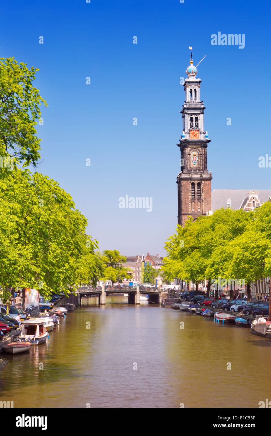 A canal and the Westerkerk church tower in Amsterdam, The Netherlands ...
