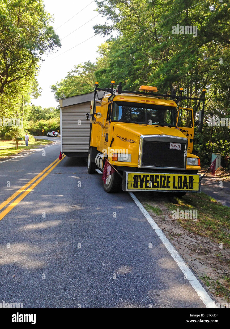 A mobile home being hauled on a single lane highway in rural USA Stock ...