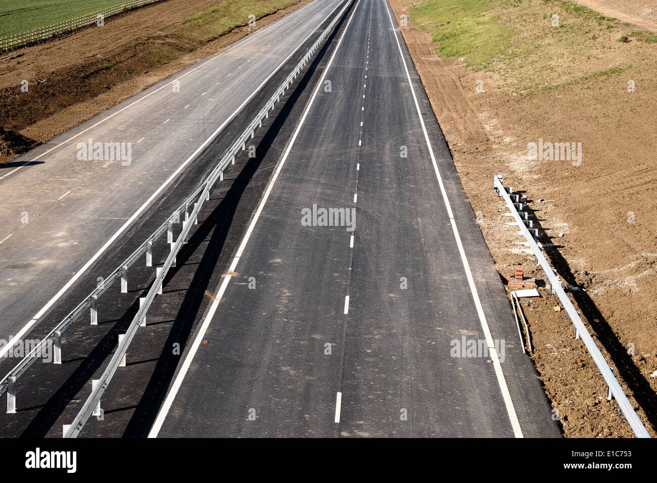 A deserted new dual carriageway road not yet in use as it is ...