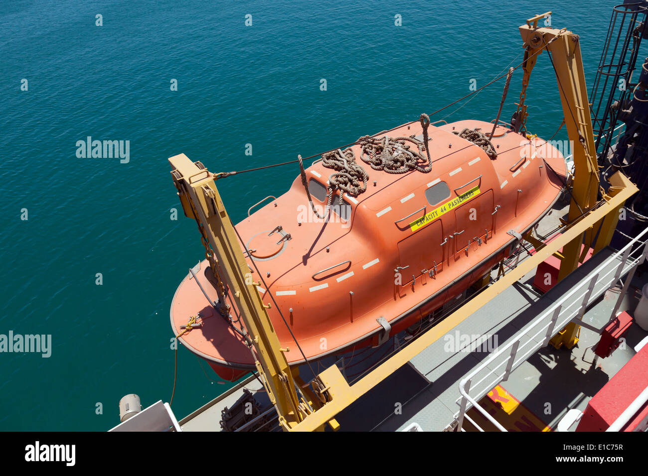 Red rescue boat hanging on the passenger ship Stock Photo - Alamy