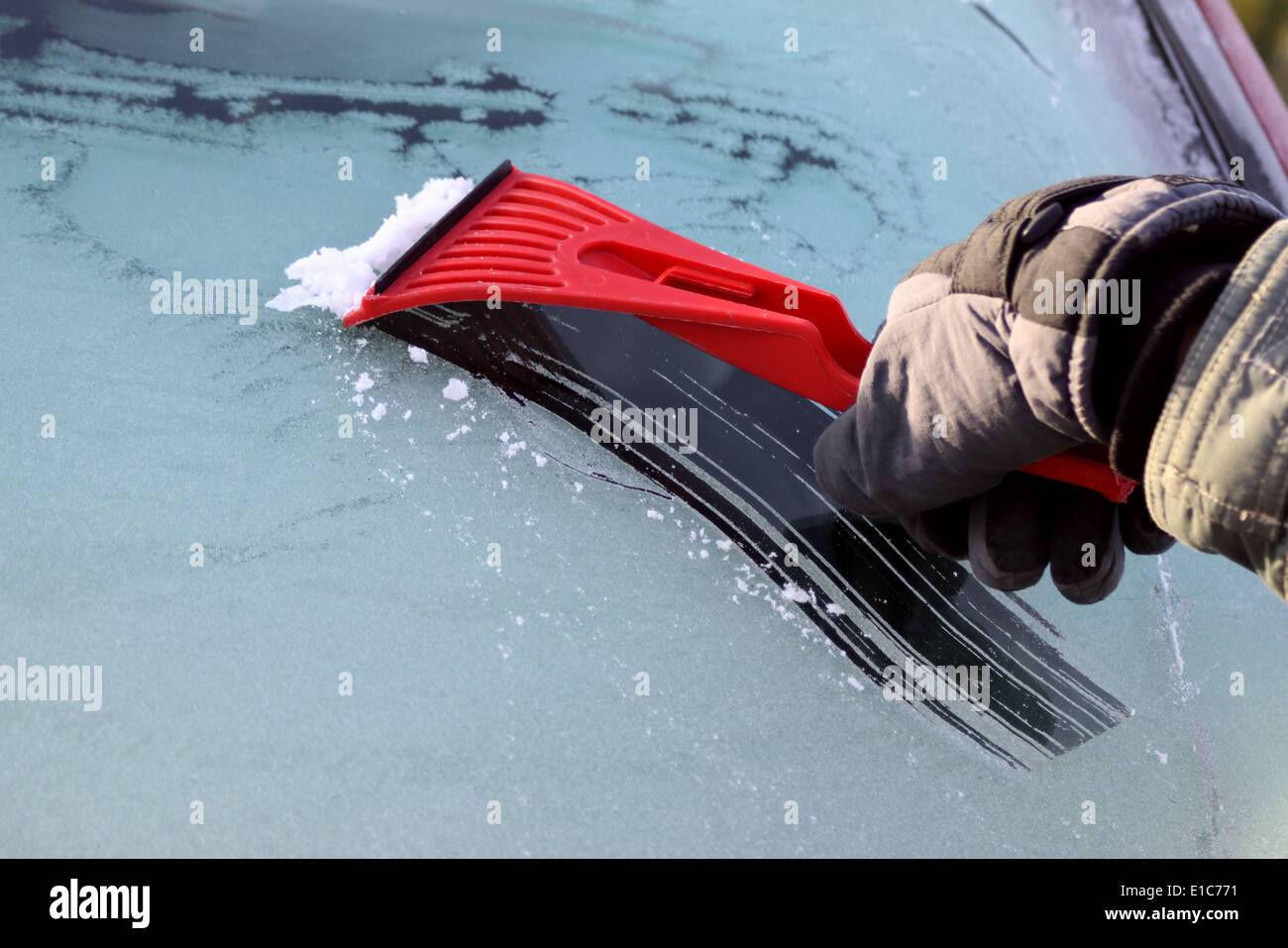 Scraping ice from the car window, with copy space on the left Stock ...