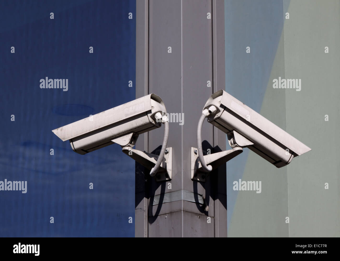 Two security cameras hanging on the building wall Stock Photo - Alamy