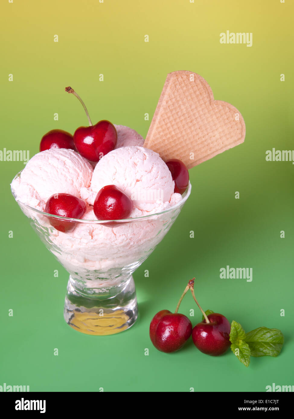 Ice cream sundae with cherries and a biscuit Stock Photo - Alamy
