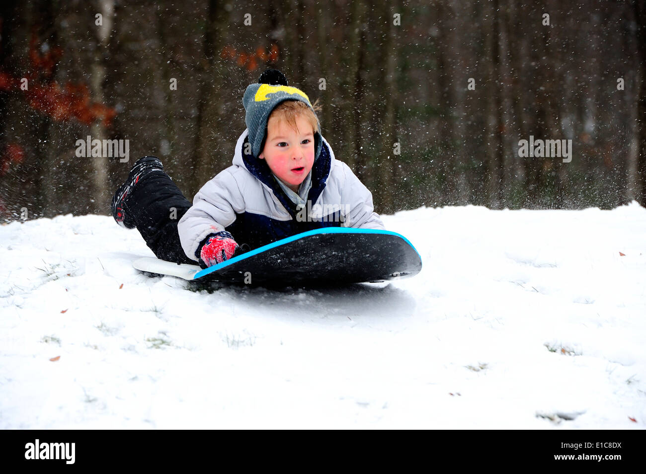 Boy riding sled hi-res stock photography and images - Alamy