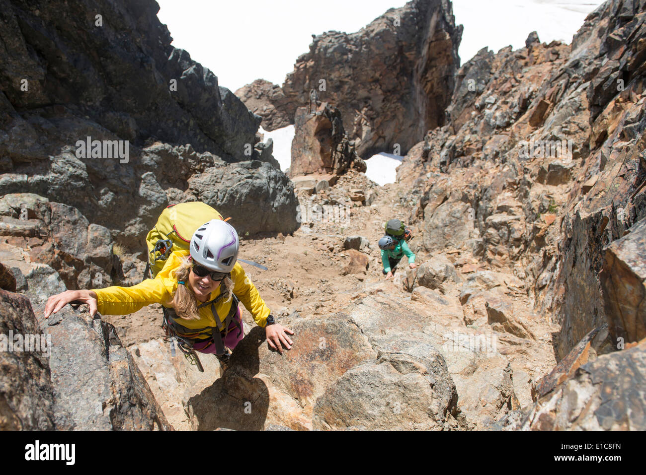 Two woman mountaineers climbing loose rock in Boston Basin, North ...