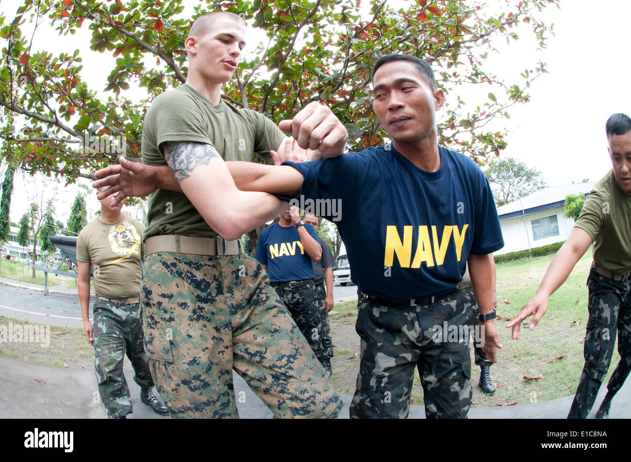 U.S. Marine Corps Lance Cpl. Kenneth Pollard, left, assigned to Fleet ...