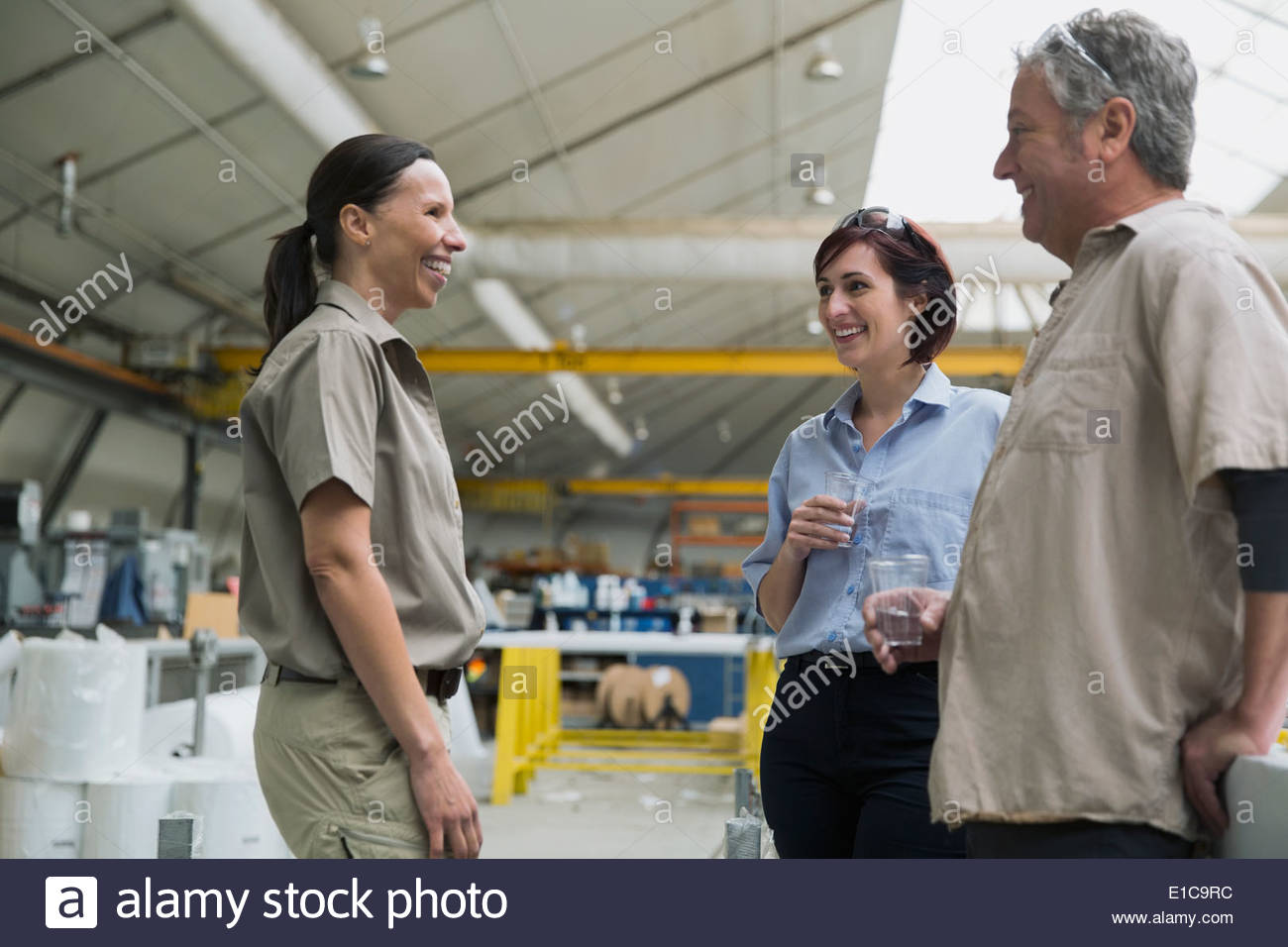 Co workers talking factory hi-res stock photography and images - Alamy