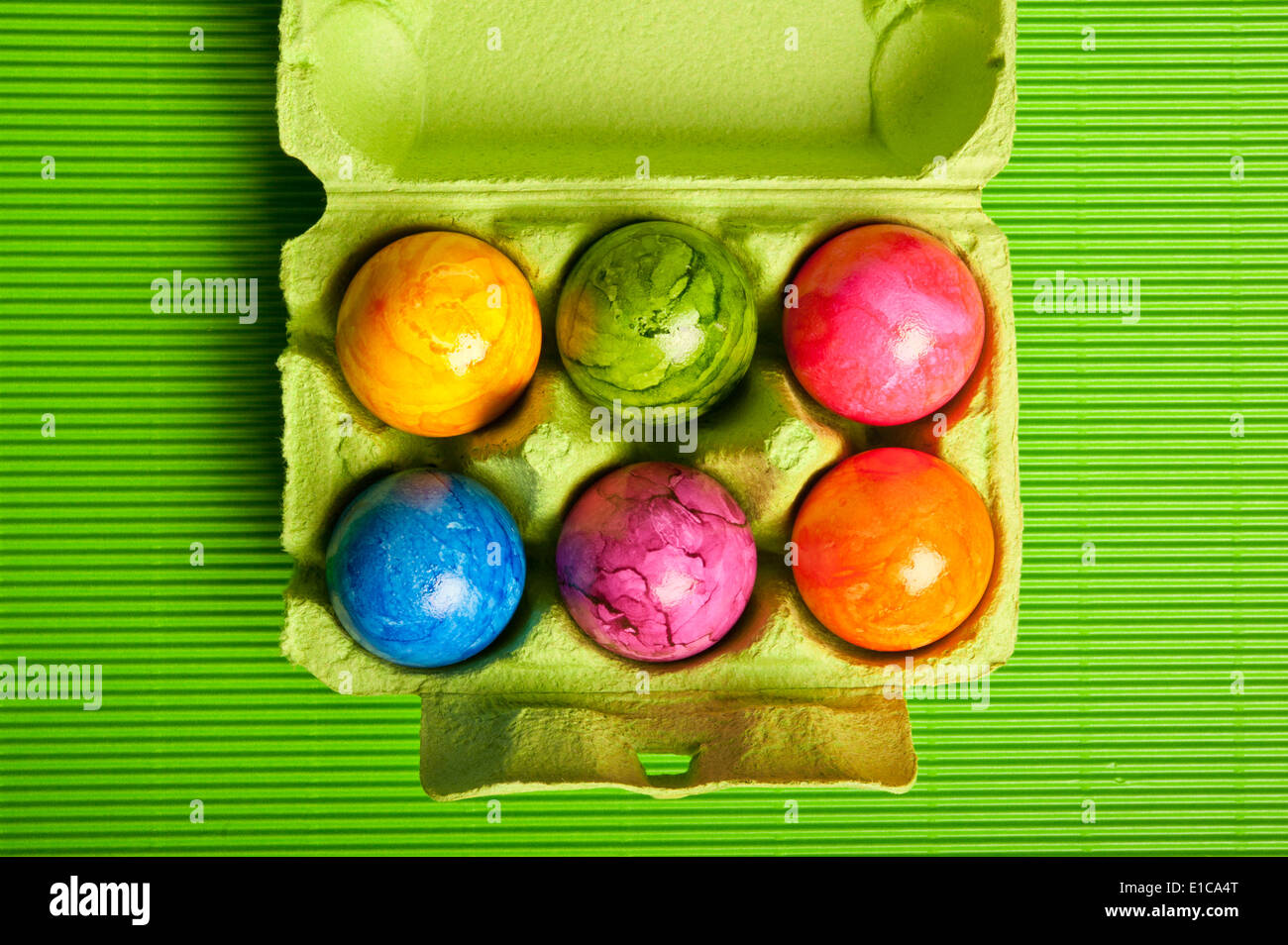 six colorful eggs in carton box Stock Photo - Alamy