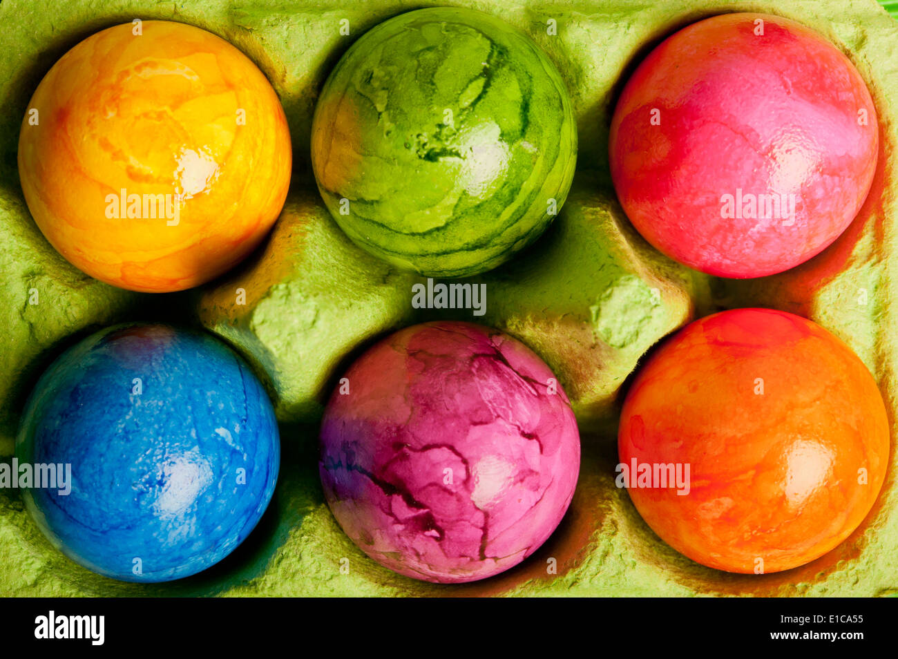 six colorful eggs in carton box Stock Photo - Alamy