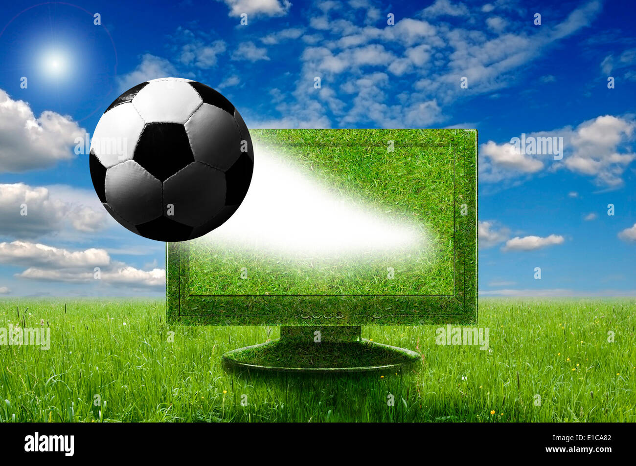 soccer ball coming out of a computer monitor Stock Photo - Alamy