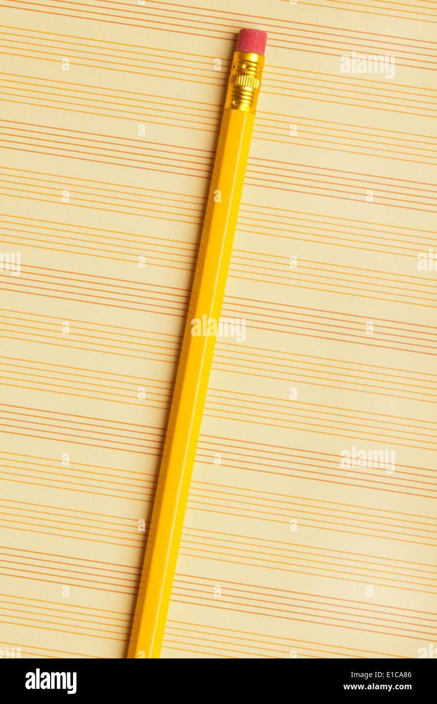 yellow pencil, bottom side, on yellow lined paper Stock Photo - Alamy