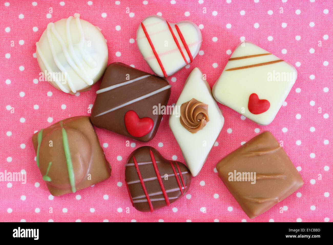 Selection of chocolates on pink background Stock Photo - Alamy