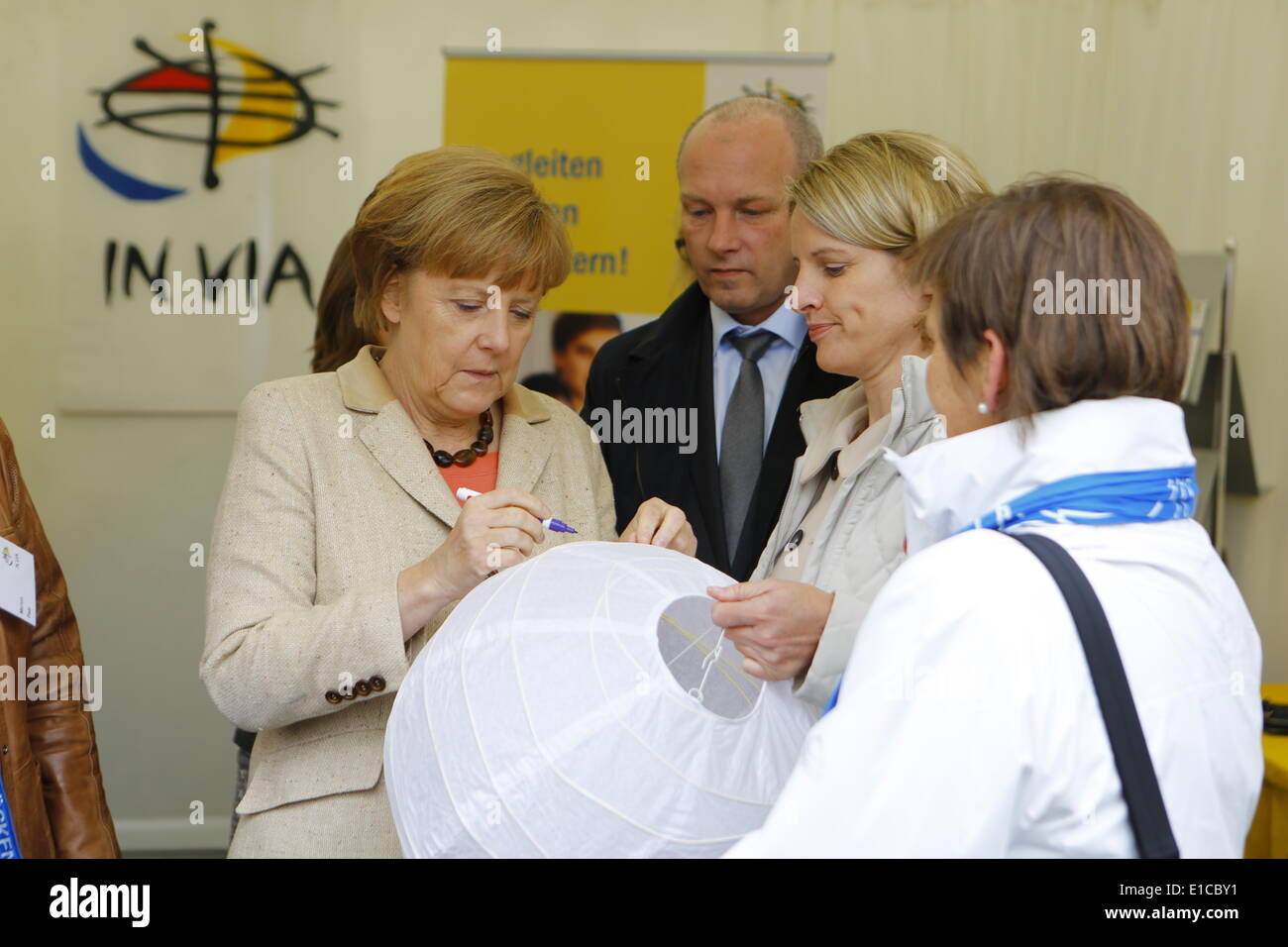 The German Chancellor Angela Merkel signs a chinese lantern with a ...