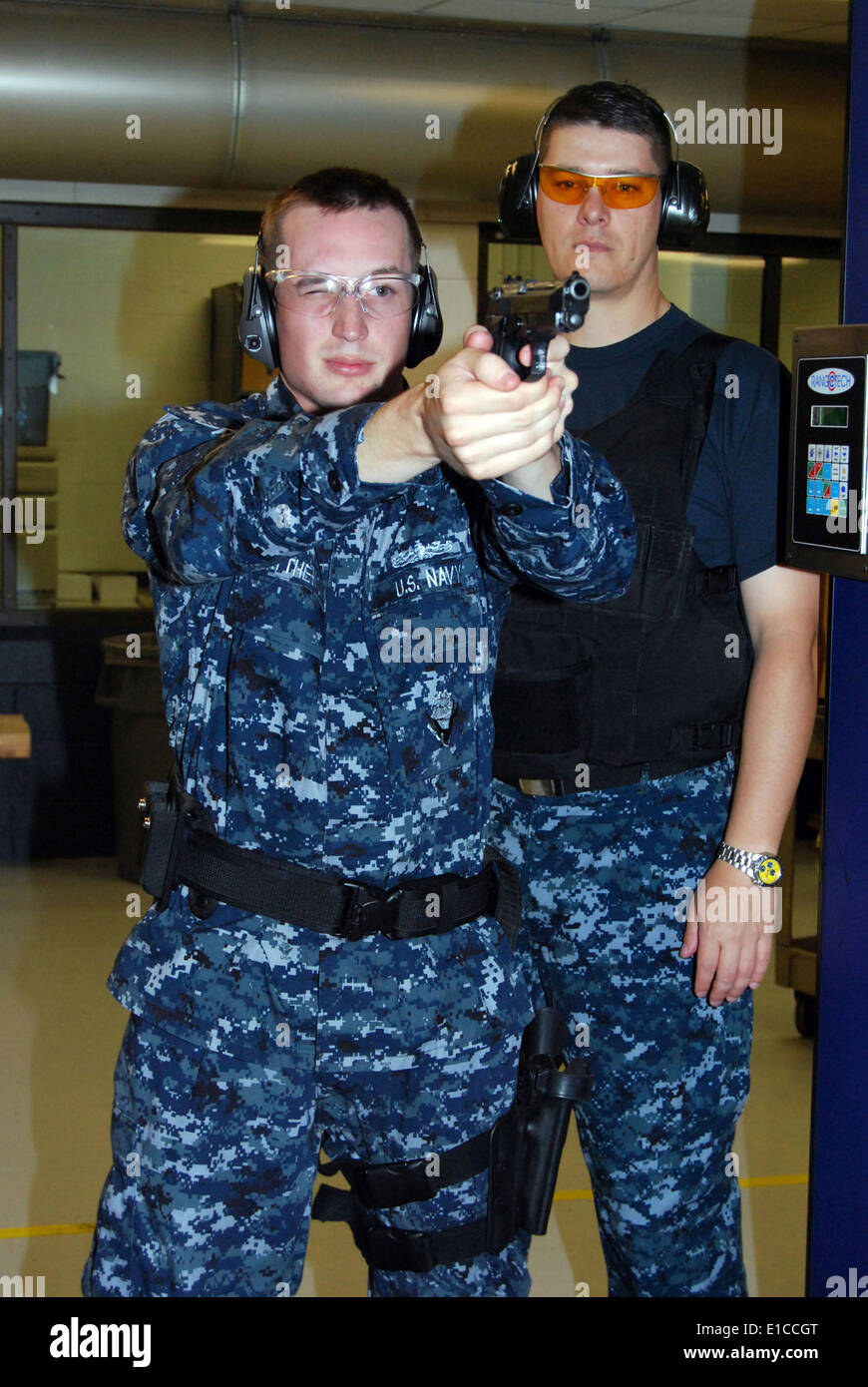 U.S. Navy Gunner?s Mate 1st Class Kenneth Matthews fires a 9 mm hand ...